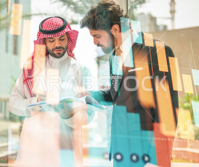 A Saudi Arabian Gulf businessman in a business meeting with a new ...