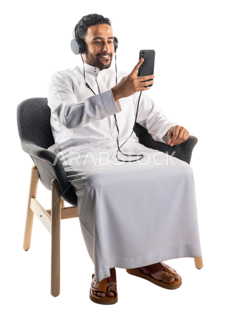Portrait of a Saudi Arabian Gulf man in Saudi dress sitting on a chair ...