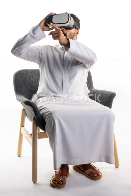 Portrait of a Saudi Arabian Gulf man dressed in Saudi uniform sitting ...