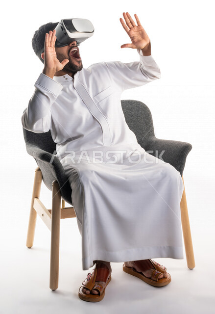 Portrait of a Saudi Arabian Gulf man dressed in Saudi uniform sitting ...