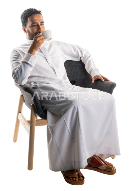 Portrait of a Saudi Arabian Gulf man wearing the Saudi thobe, sitting ...