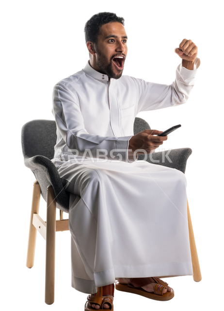 Portrait of a Saudi Arabian Gulf man wearing a Saudi dress, sitting on ...