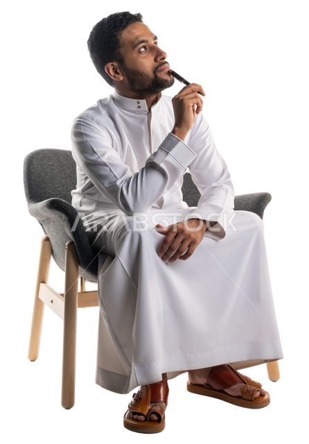 Portrait of a Saudi Arabian Gulf man wearing the Saudi dress sitting on ...