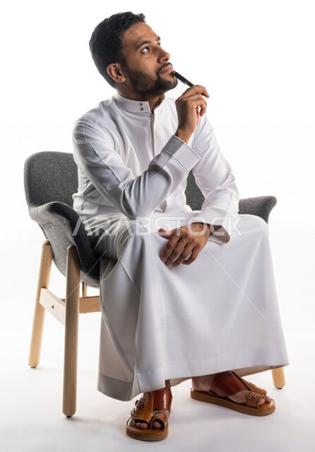 Portrait of a Saudi Arabian Gulf man wearing the Saudi dress sitting on ...