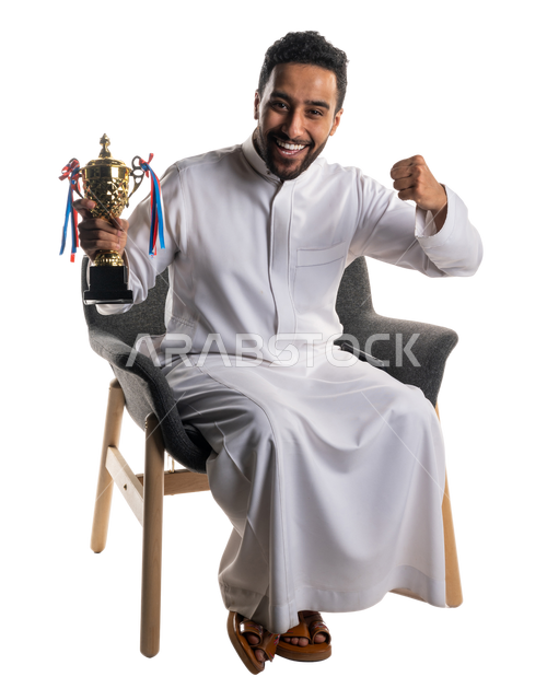 Portrait of a Saudi Arabian Gulf man wearing the Saudi uniform sitting ...