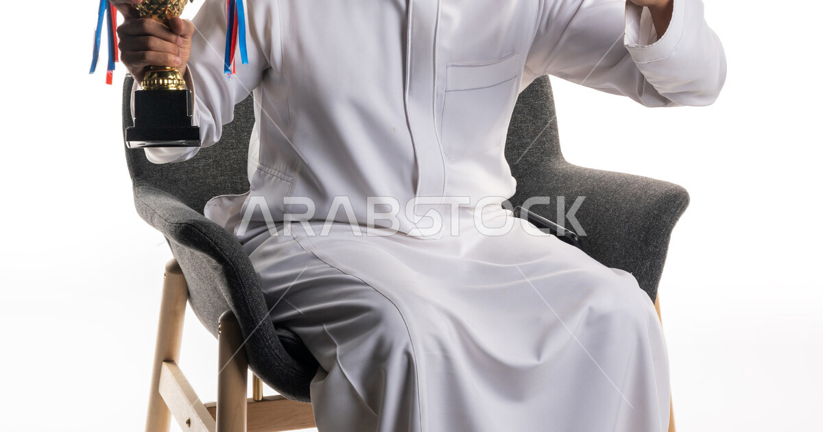 Portrait of a Saudi Arabian Gulf man wearing the Saudi uniform sitting ...