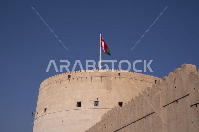 Close-up of Nizwa Castle in the Sultanate of Oman, flagpole, Oman flag ...