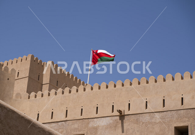 A picture of the flag of Oman flying in the Al Hazm Fort in the city of ...