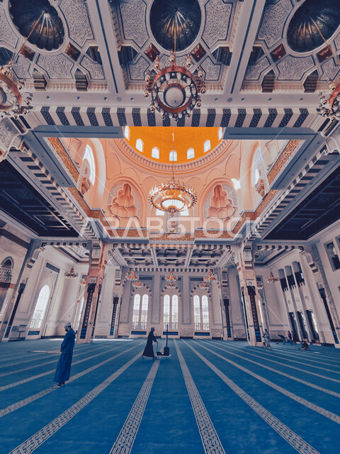 A group of worshipers inside the mosque, Islamic designs and ...