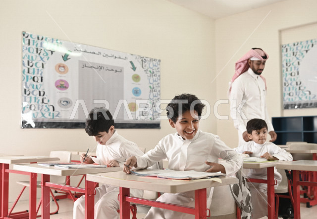 A Saudi Arabian Gulf teacher who helps students to solve questions in ...