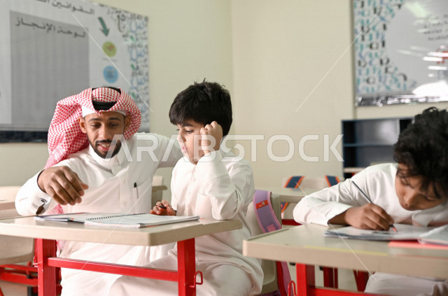 A Saudi Arabian Gulf teacher who helps students to solve questions in ...