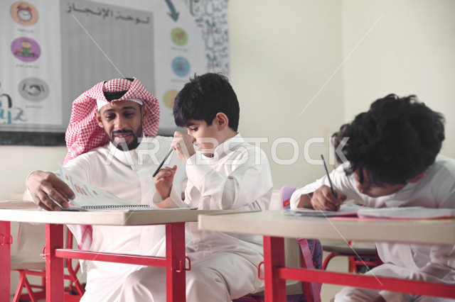 A Saudi Arabian Gulf teacher who helps students to solve questions in ...