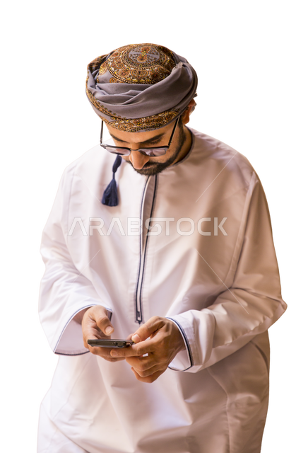 Omani Gulf Arab man using his mobile phone, accomplishing work tasks ...