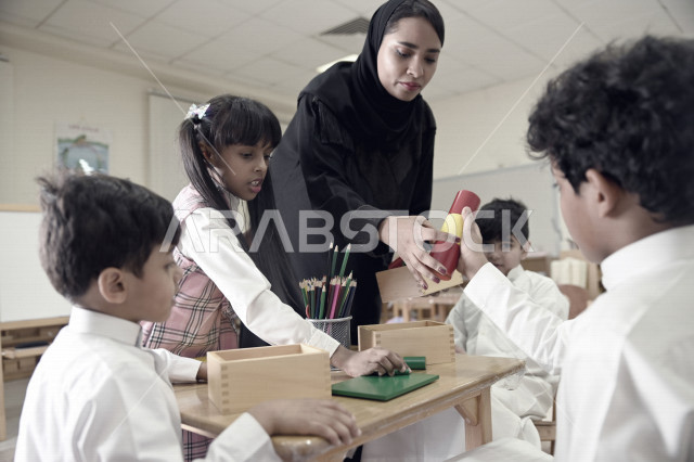 A Saudi Arabian Gulf teacher who helps male and female students to make ...