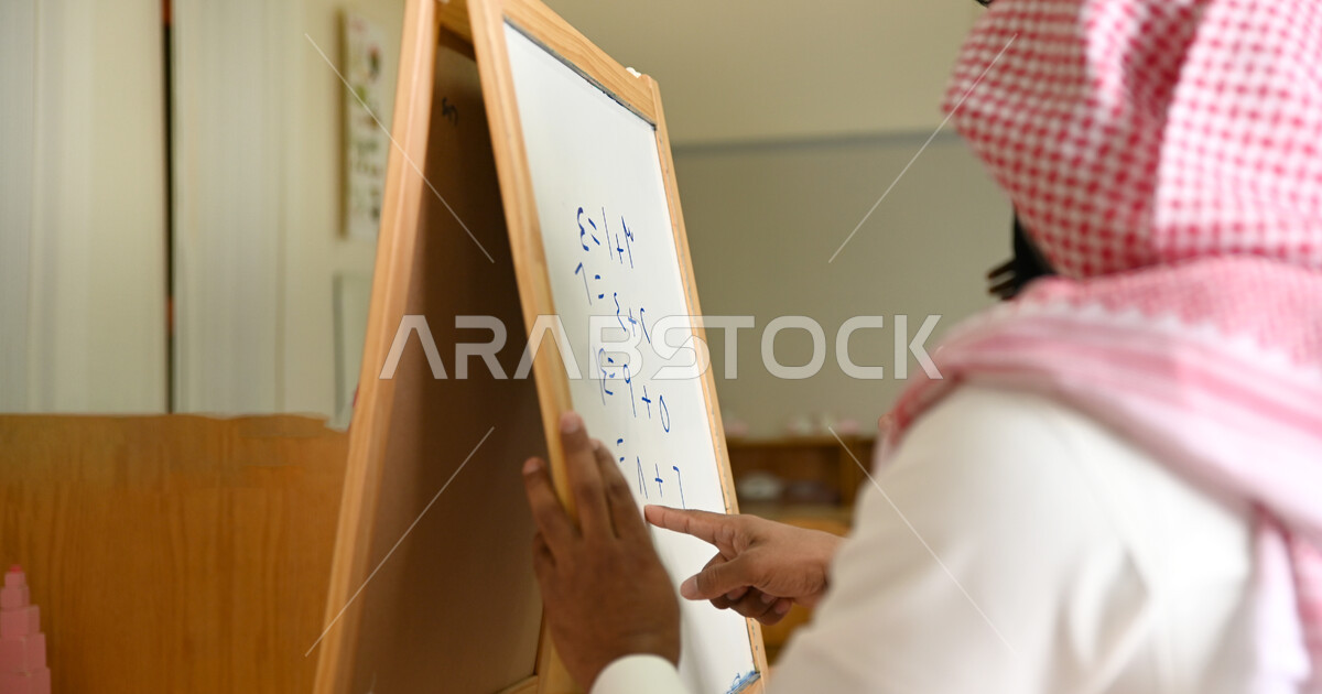A Saudi Arabian Gulf mathematics teacher explaining simple math ...