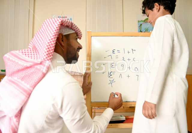A Saudi Arabian Gulf mathematics teacher explaining simple math ...