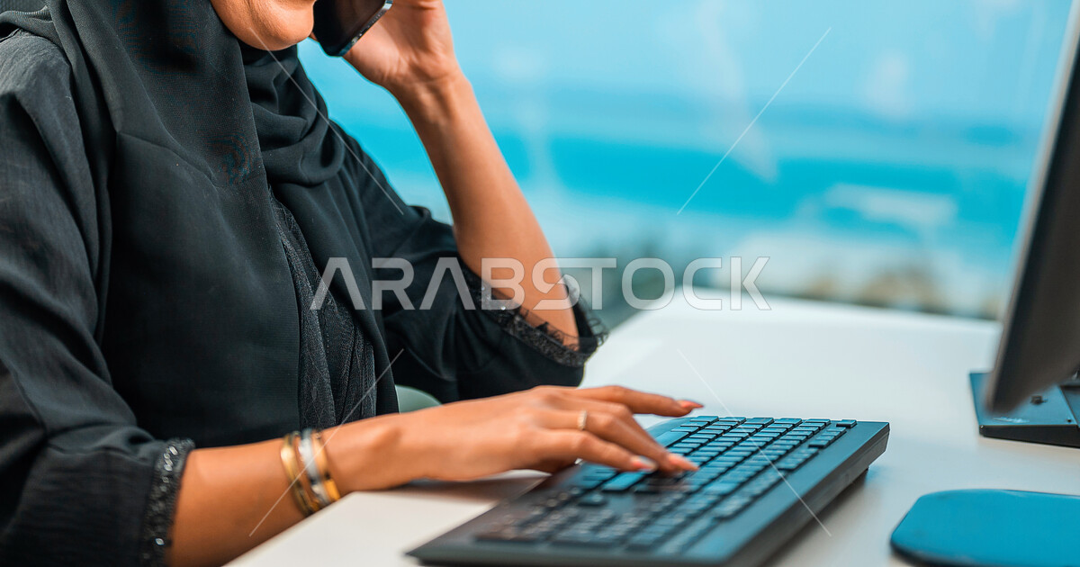 A Saudi Arabian Gulf business woman wearing the abaya works at the ...