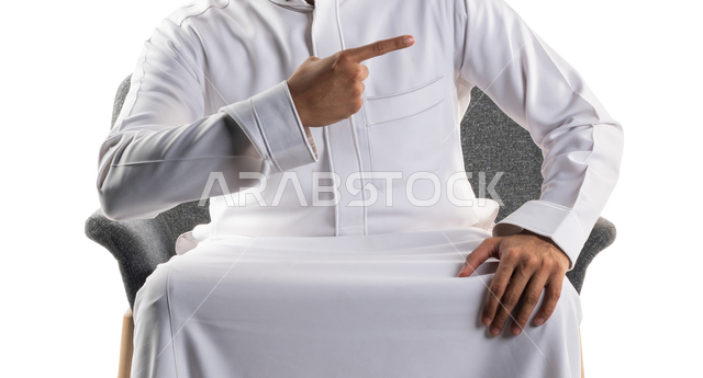 Portrait of a Saudi Arabian Gulf man wearing the Saudi thobe sitting on ...