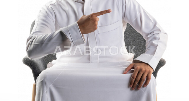 Portrait of a Saudi Arabian Gulf man wearing the Saudi thobe sitting on ...
