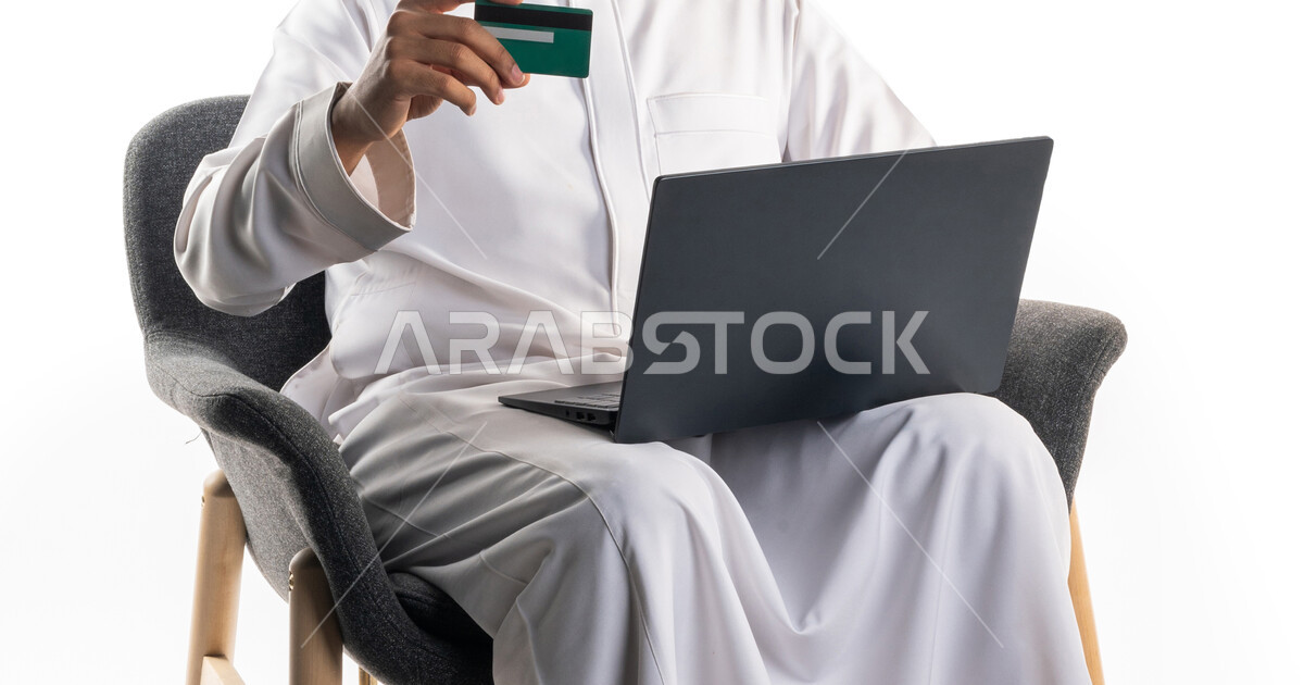 Portrait of a Saudi Arabian Gulf man in Saudi dress sitting on a chair ...