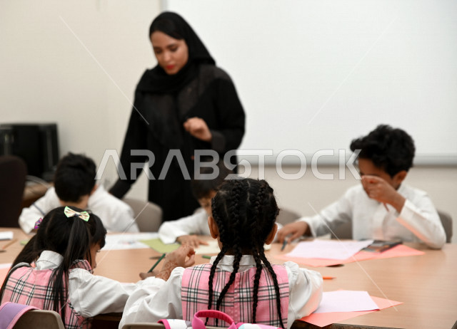 A Saudi Arabian Gulf teacher who monitors male and female students and ...