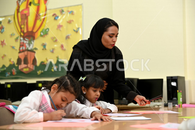 A Saudi Arabian Gulf teacher who monitors male and female students and ...