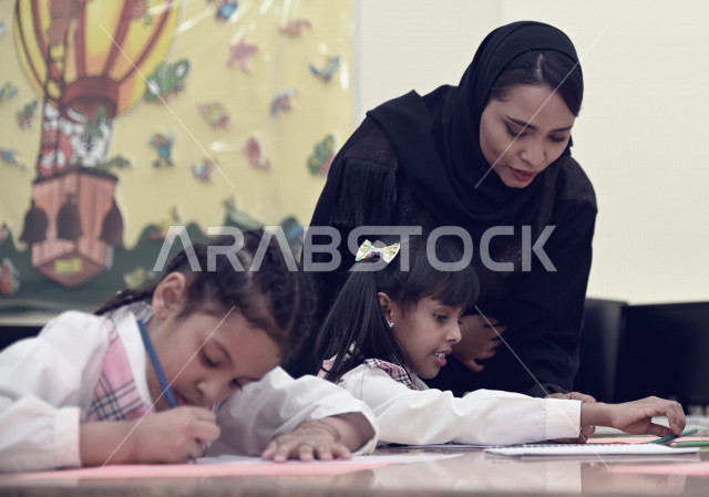 A Saudi Arabian Gulf teacher who monitors male and female students and ...
