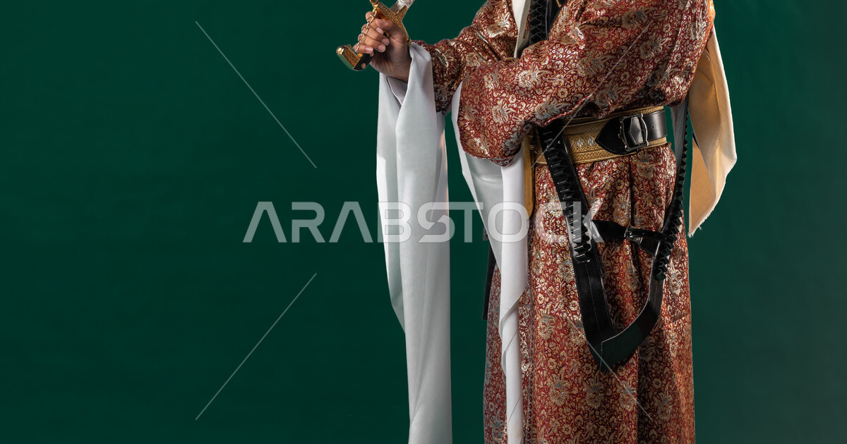 A chroma of a Saudi Arabian Gulf man, holding a sword in his hand ...