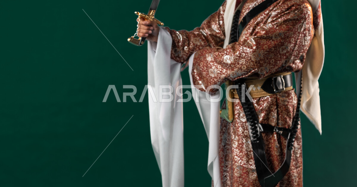 A chroma of a Saudi Arabian Gulf man, holding a sword in his hand ...