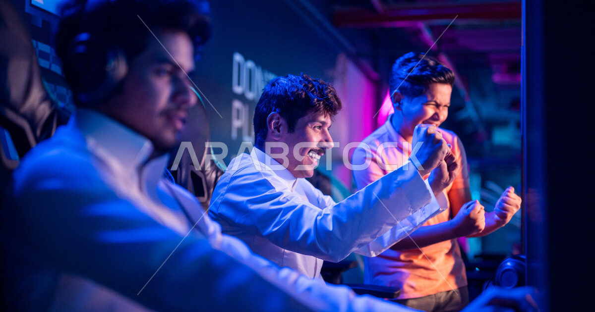 Arab youth Gulf Saudi teenagers in the electronic games store, wearing ...