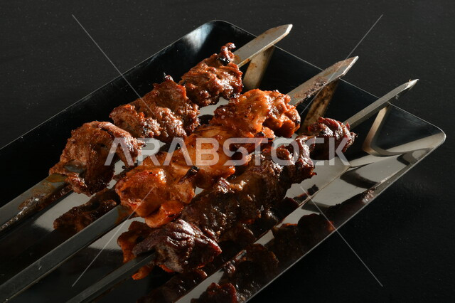 Skewers of grilled meat and chicken, a grill meal, a plate of delicious ...