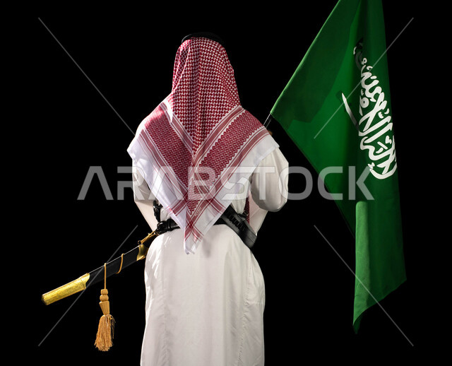 Portrait from the back of a Saudi Arabian Gulf man raising the Saudi ...