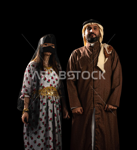 Portrait of a Saudi Arabian Gulf woman and man wearing traditional ...