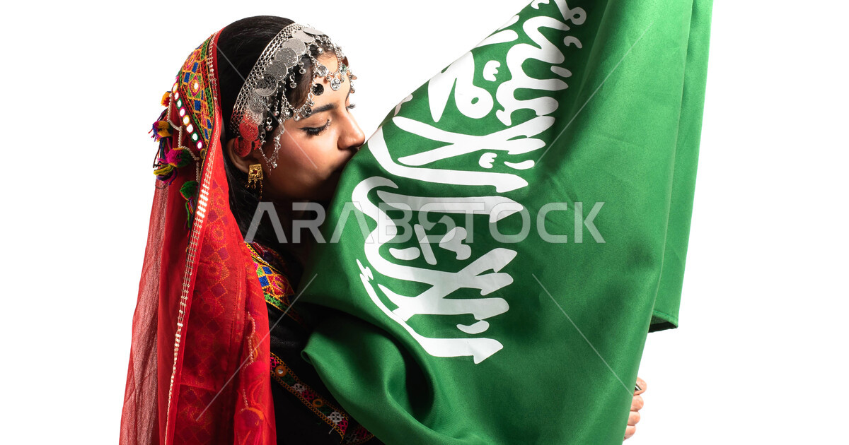 Portrait of a Saudi Arabian Gulf woman accepting the Saudi flag ...