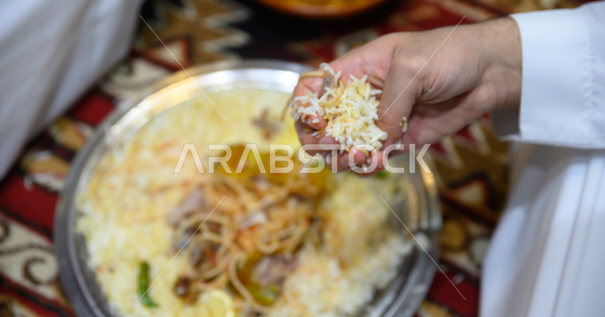 Two young Saudi Arabian Gulf men gathered at the dining table, Ramadan ...