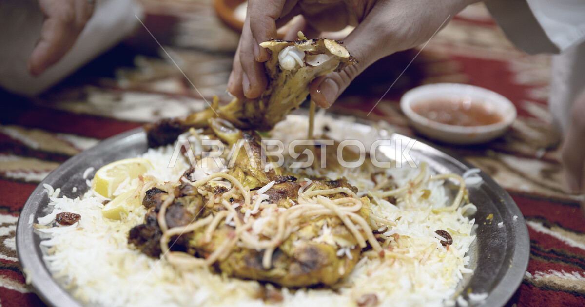 Two young Saudi Arabian Gulf men gathered at the dining table, Ramadan ...