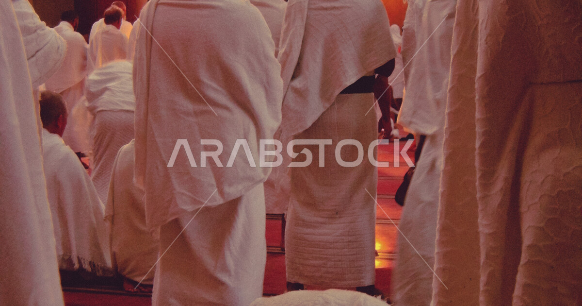 A group of Muslim pilgrims wearing the Ihram dress, performing prayer ...