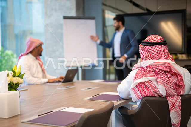 A Saudi team and a man in a formal suit in the meeting room inside the ...