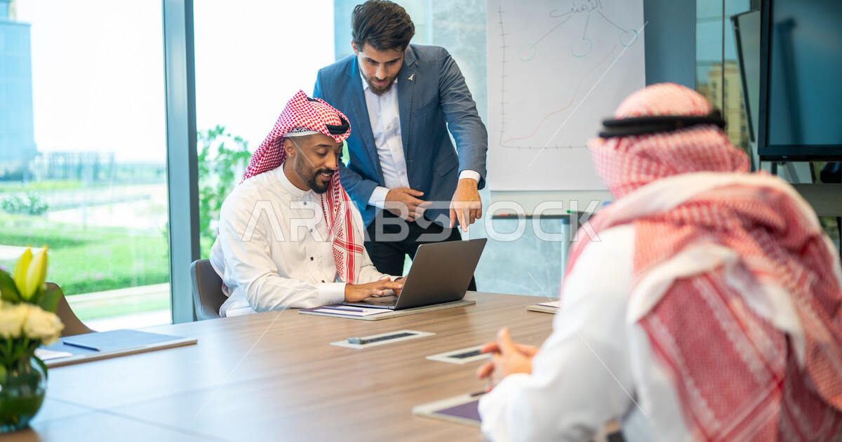 A Saudi team and a man in a formal suit in the meeting room inside the ...