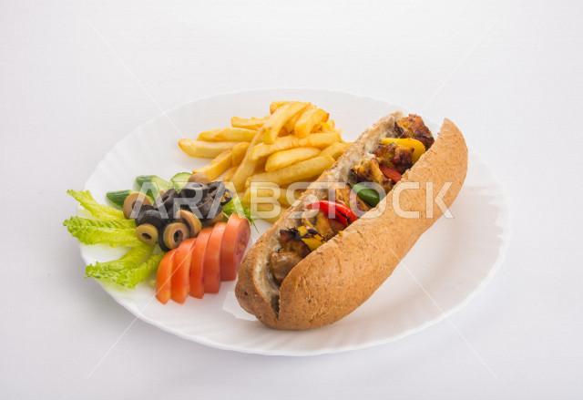 A plate of grilled chicken sandwich, shish tawook, samoli bread stuffed ...