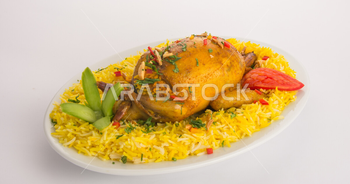 A plate of rice with chicken stuffed with pasta, kabsa with mandi ...