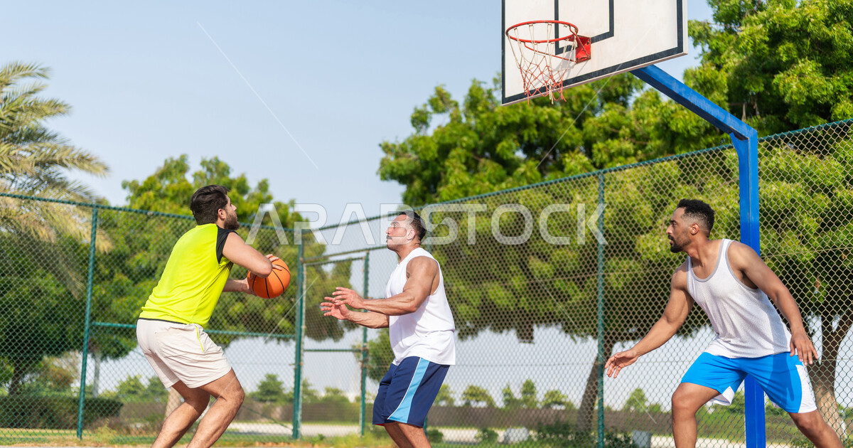 A team of Saudi Arabian Gulf friends playing basketball, practicing ...