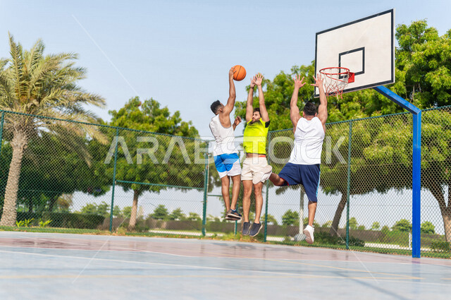 A team of Saudi Arabian Gulf friends playing basketball, practicing ...