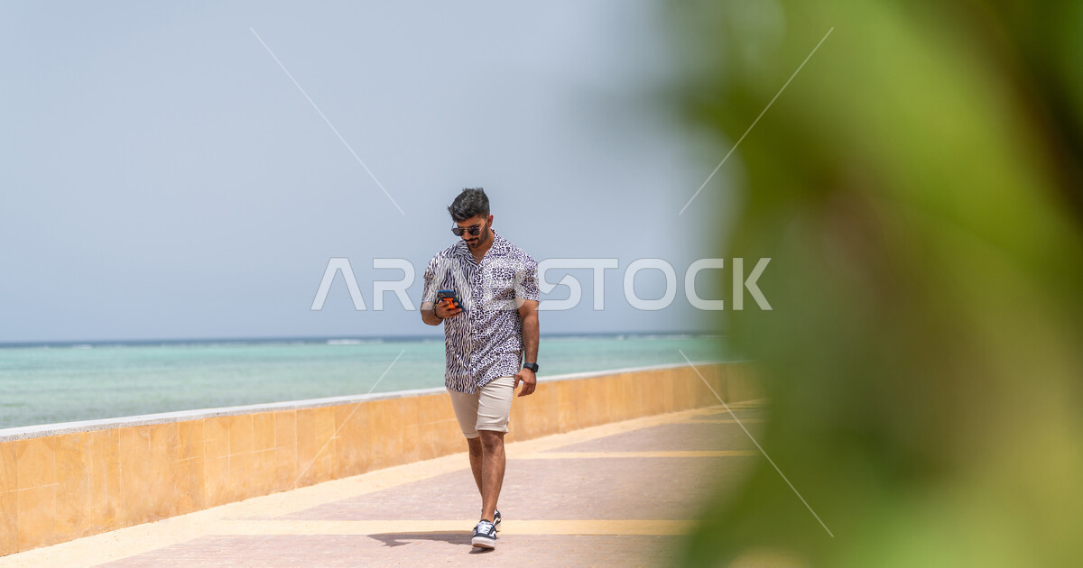 A Saudi Arabian Gulf man practicing walking in the Jeddah Corniche ...