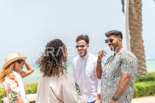 A group of Saudi Arab Gulf friends meet on the promenade of the Jeddah ...