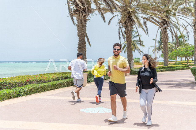 A Saudi Arabian Gulf man and woman practicing jogging, maintaining ...