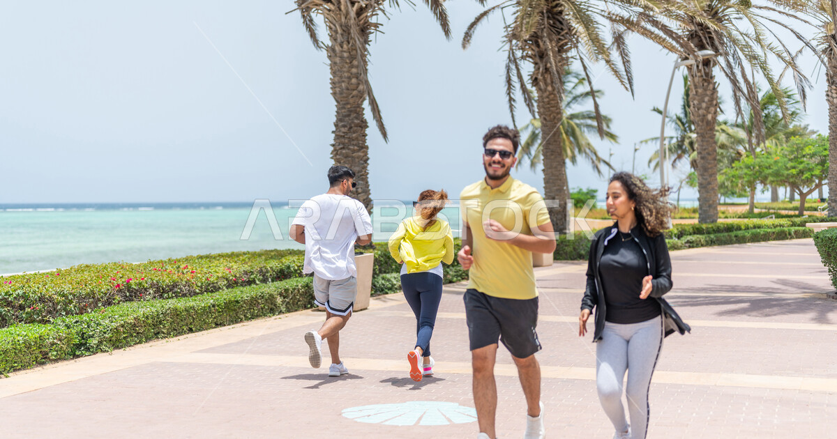 A Saudi Arabian Gulf man and woman practicing jogging, maintaining ...