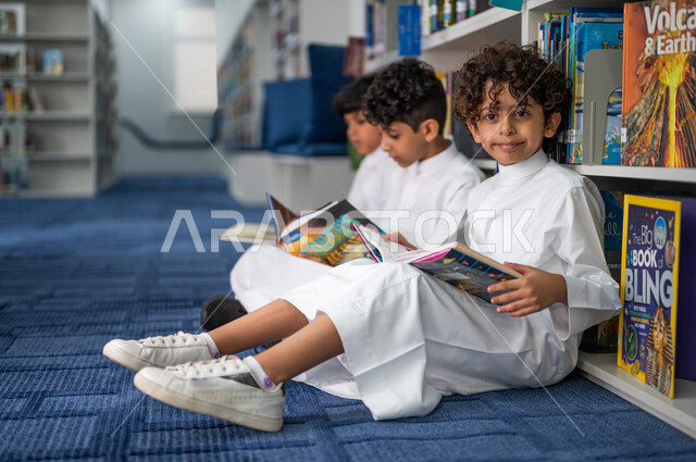 Saudi Arabian Gulf students sitting in the school library, enjoying ...