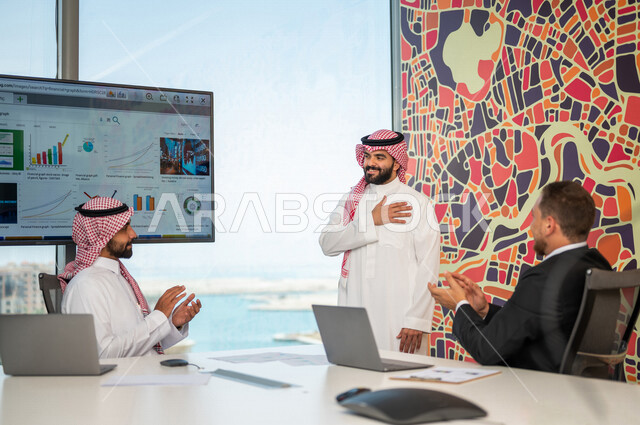 A Saudi team and a man in a formal suit in the meeting room inside the ...