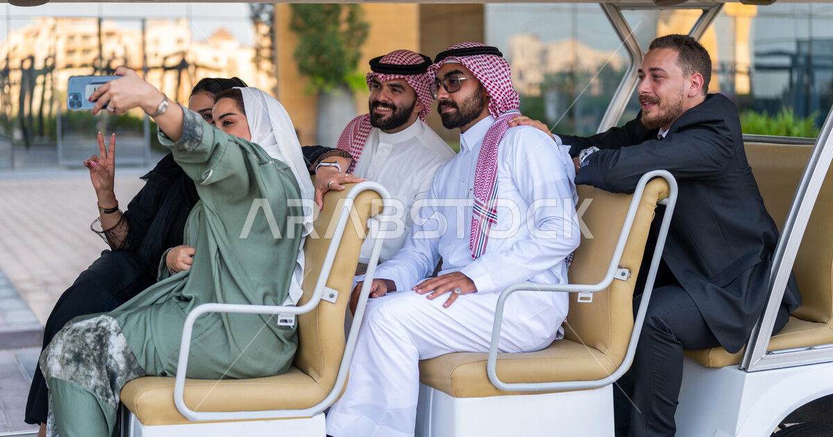 A group of Saudi Arab people inside an electric car specialized in ...